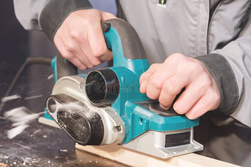 The Hands of a Carpenter Working Woodworking Power Tools. Close Up of ...