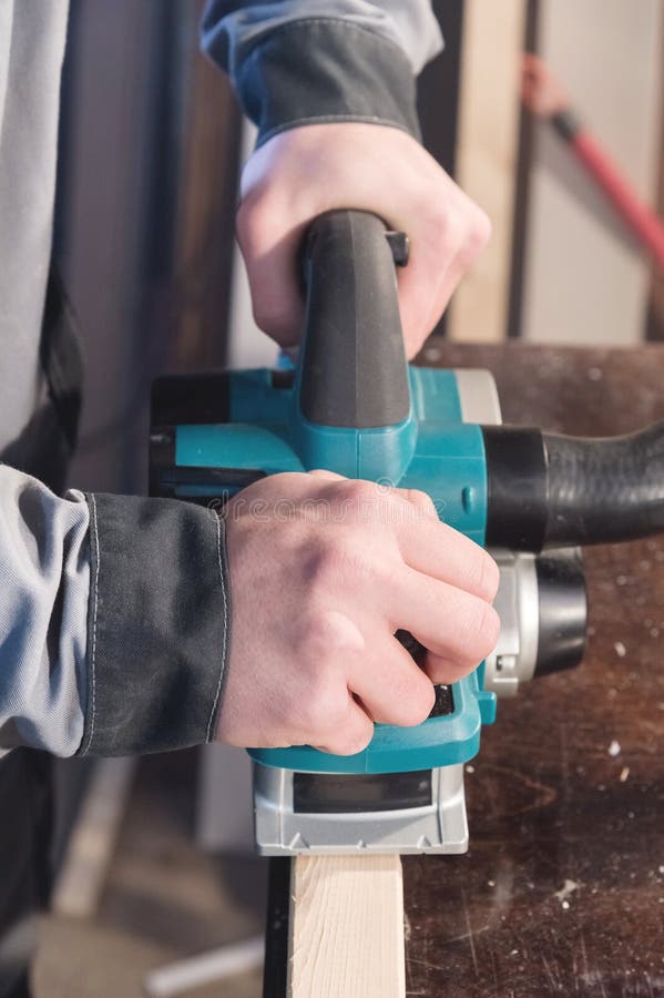 The Hands of a Carpenter Working Woodworking Power Tools. Close Up of ...
