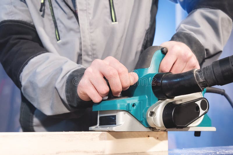 The Hands of a Carpenter Working Woodworking Power Tools. Close Up of ...