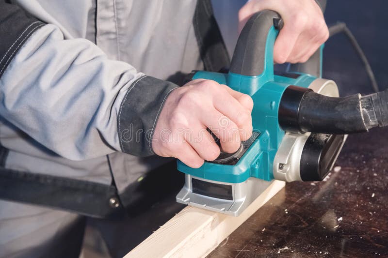 The Hands of a Carpenter Working Woodworking Power Tools. Close Up of ...