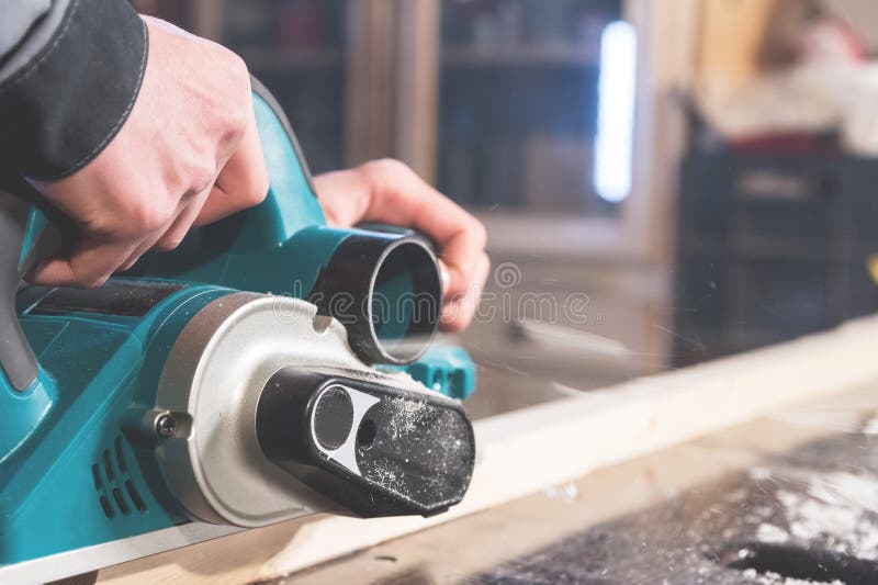 The Hands of a Carpenter Working Woodworking Power Tools. Close Up of ...