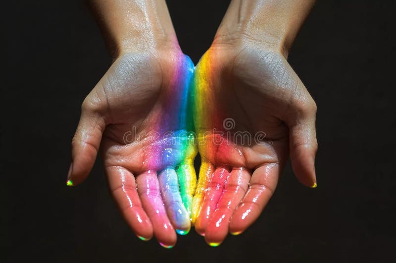 Hands Catch a Rainbow in Sunlight during a Serene Outdoor Moment of ...