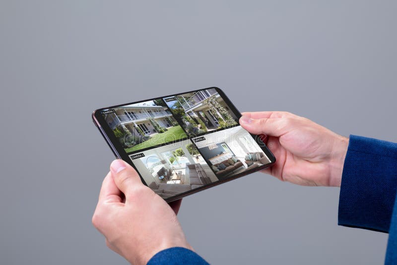 Hands of Caucasian Man Holding Tablet with View of Home from Security ...