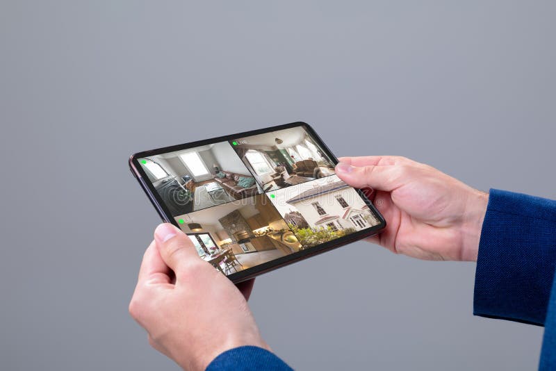 Hands of Caucasian Man Holding Tablet with View from Security Cameras ...