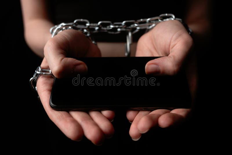 Hands Chained Holding a Mobile Device Symbolizing Digital Addiction ...