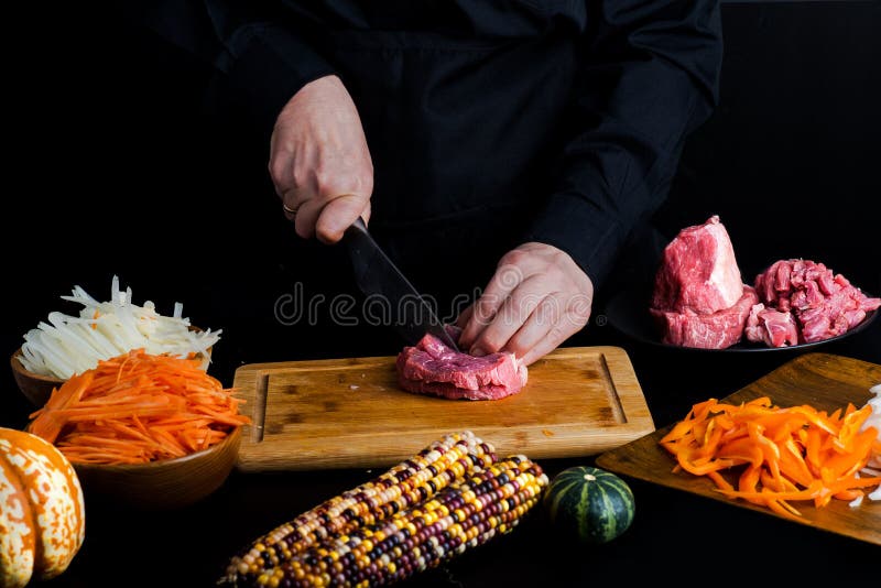 Hands of the Chef Cut Meat on the Black Table Stock Image - Image of ...