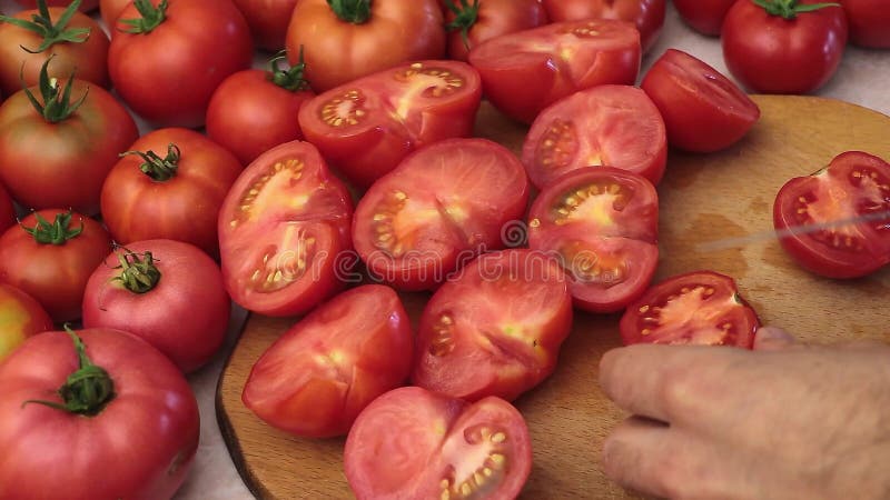 The Hands of a Chef Cutting Tomatoes in Half with a Knife - Recipe ...