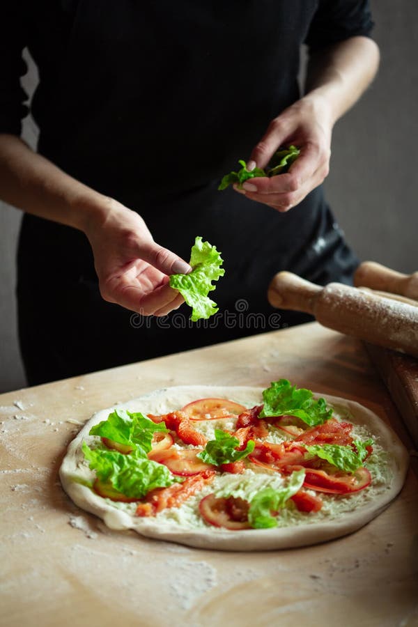 Hands of Chef Preparing Pizza. Putting Ingredients on Rolled Dough ...