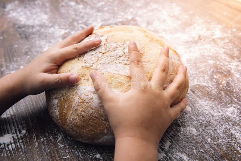 Hands of a Child on a Loaf of Rustic Bread Stock Photo - Image of ...