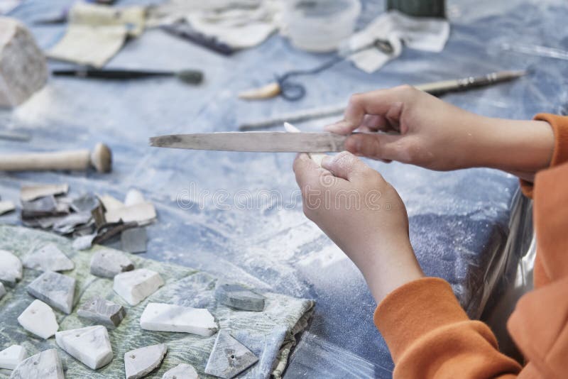 Hands of Child Processing Ornamental Stone with File at Stone Carving ...