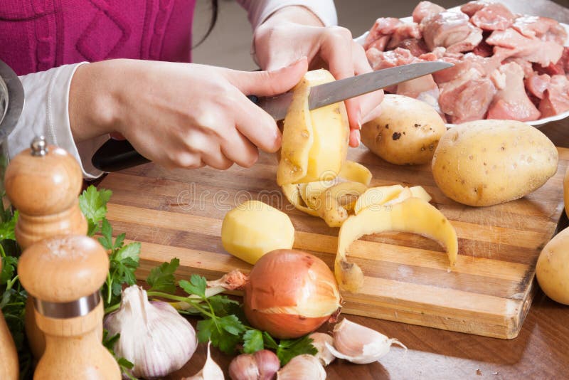 Hands Cleaning Potatoes at Table in Kitchen Stock Photo - Image of food ...