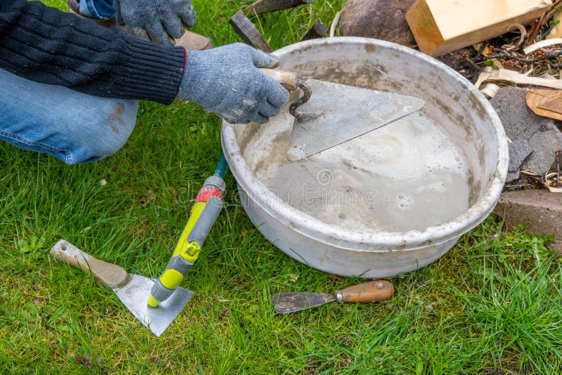 Two Hands, Two Trowels! stock photo. Image of trowel, slab - 583660