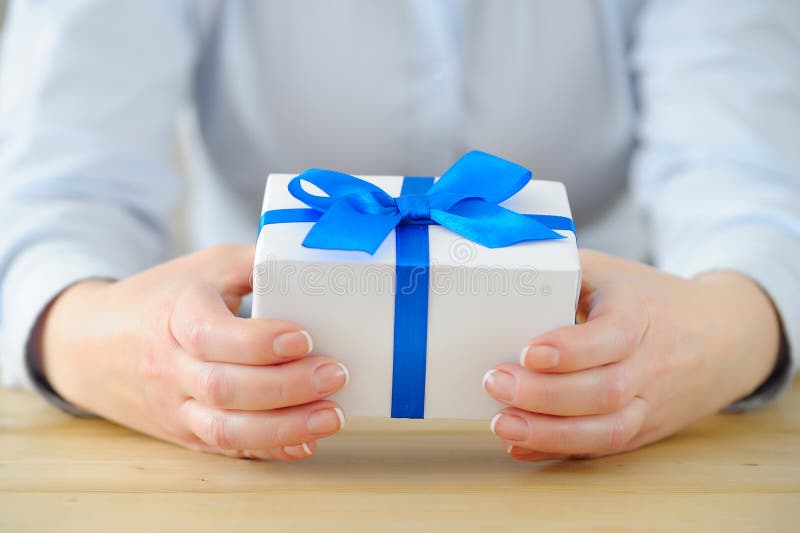 Hands Closeup. Gift with Blue Ribbon in Hands. Stock Image - Image of ...