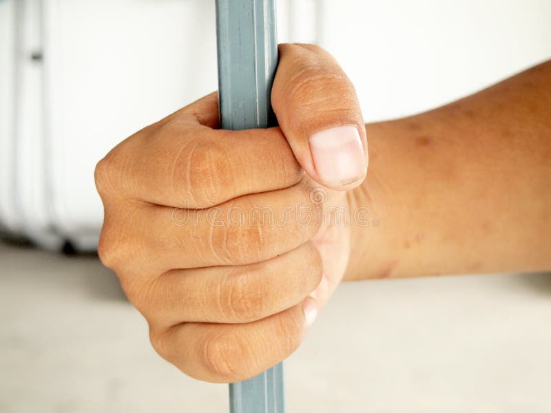Hands clutching bars stock image. Image of link, mesh - 55303995
