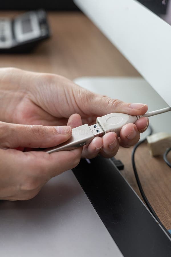 Hands Connecting USB Cable between Two Devices in a Tech Setup Stock ...