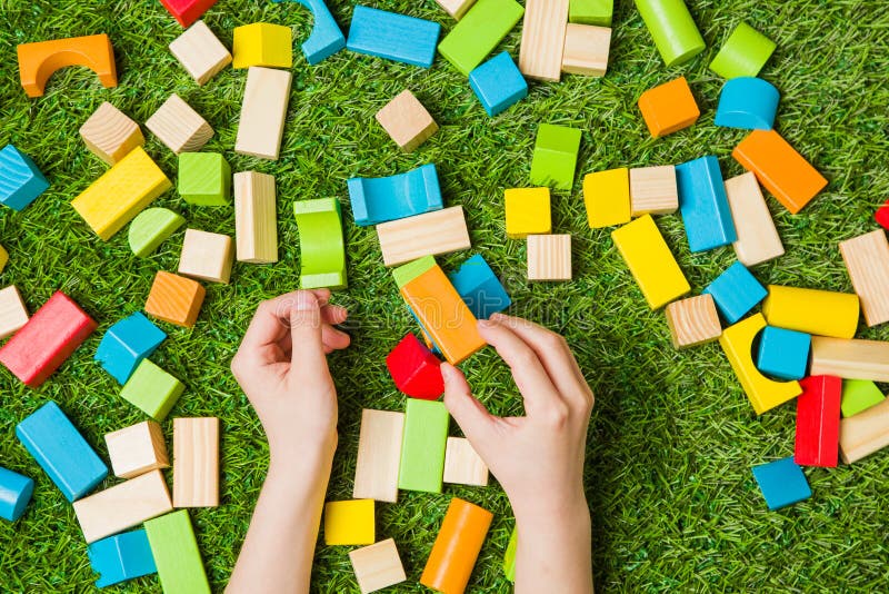Hands Constructing from Color Wooden Blocks Stock Photo - Image of ...