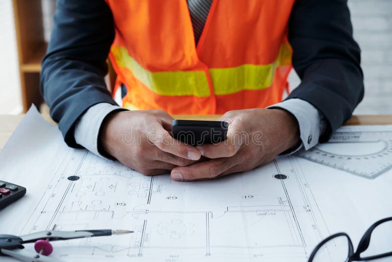 Engineer Texting To Colleague Stock Photo - Image of serious, reading ...