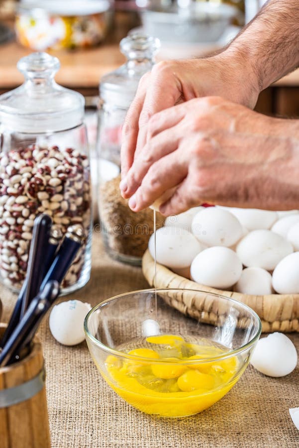 The Hands of the Cook Break an Egg into a Bowl Stock Photo - Image of ...