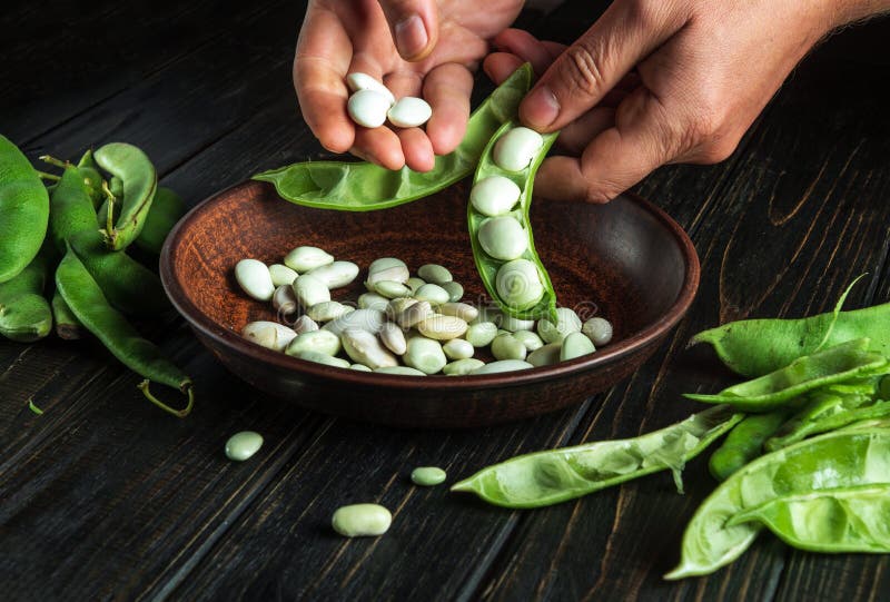 The Hands of the Cook Clean the Green Bean Pods. Working Environment on ...