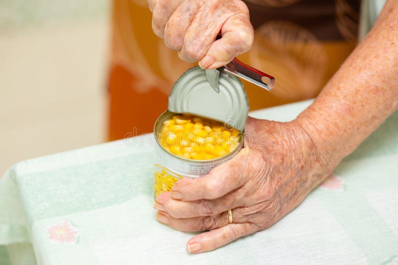 Hands of a Cook Opening a Can of Corn. Stock Photo - Image of canning ...