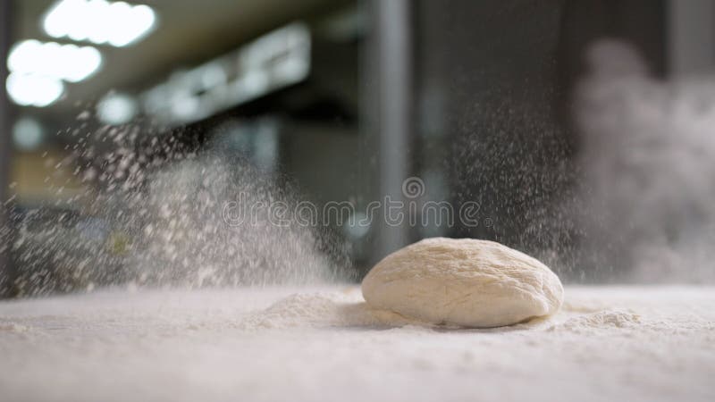A Male Baker Throws Raw Dough into Flour in a Restaurant Kitchen. Close ...