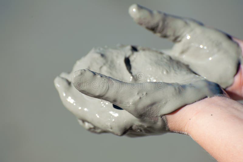 Hands Covered with Grey Mud, Held Open and Face Up - Close Up Stock ...