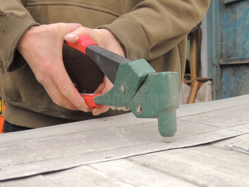 Hands of a Craftsman with a Riveting Gun at Work Stock Photo - Image of ...