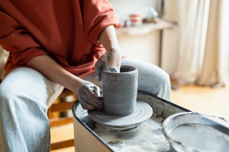 Craftswoman at Work Scraping and Shaping Clay Pottery Jug with ...