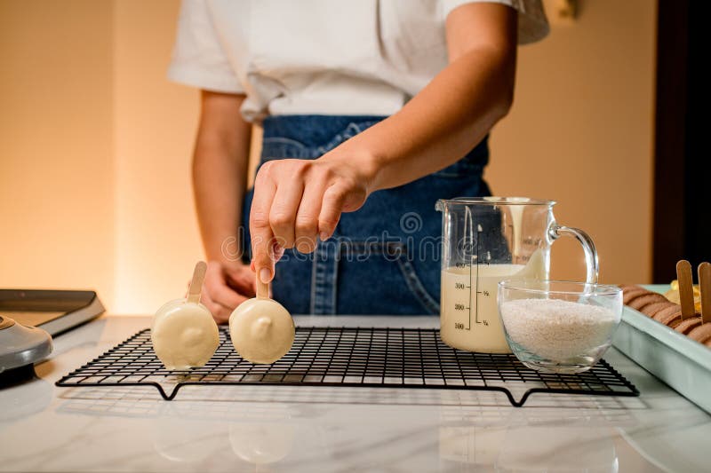 Hands of Culinary Making a Macaron in White Chocolate on a Beige ...