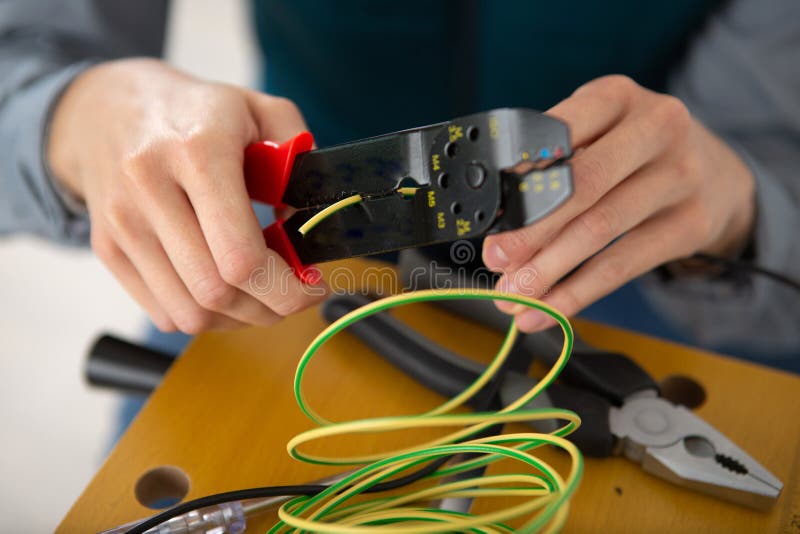 Hands cut electric cable stock image. Image of case - 254760199