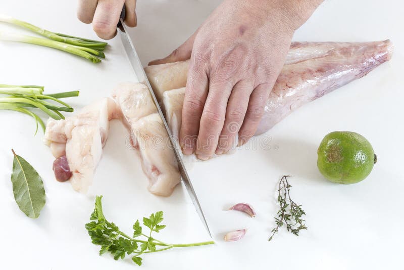Cutting a monkfish filet stock image. Image of professional - 71144823