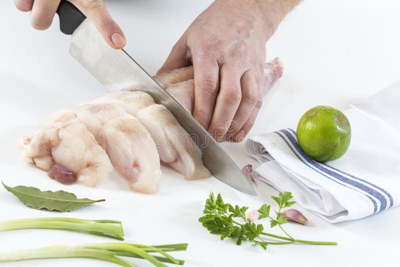 Cutting a monkfish filet stock image. Image of professional - 71144823