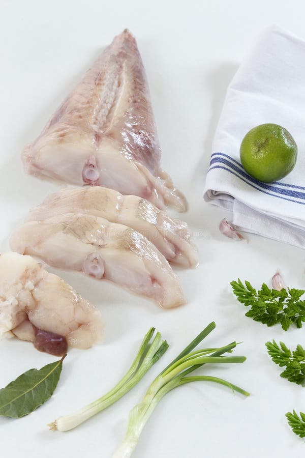 Hands Cuting Monkfish Slices on a White Background Stock Photo - Image ...