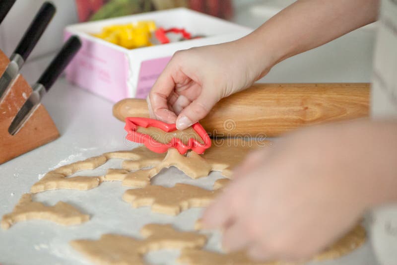 Hands cutting out cookies stock image. Image of cute - 79605503