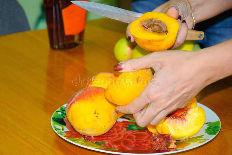 Hands are Cutting Peaches Over a Plate Stock Photo - Image of perfect ...