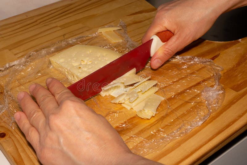 Hands Cutting a Piece of Cheese into Slices Stock Image - Image of ...