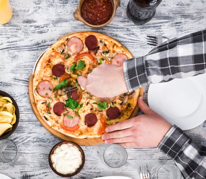 Hands Cutting Pizza on Table Stock Image - Image of slicing, delicious ...