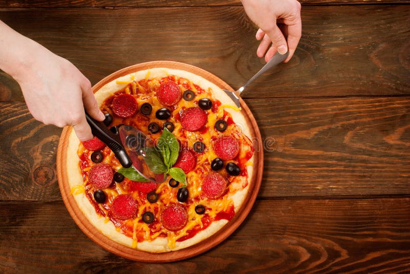 Hands Cutting Pizza on Wooden Table Stock Image - Image of cuisine ...