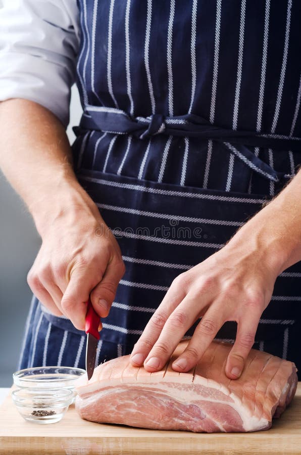 Hands cutting raw meat stock image. Image of meat, scored - 58025015