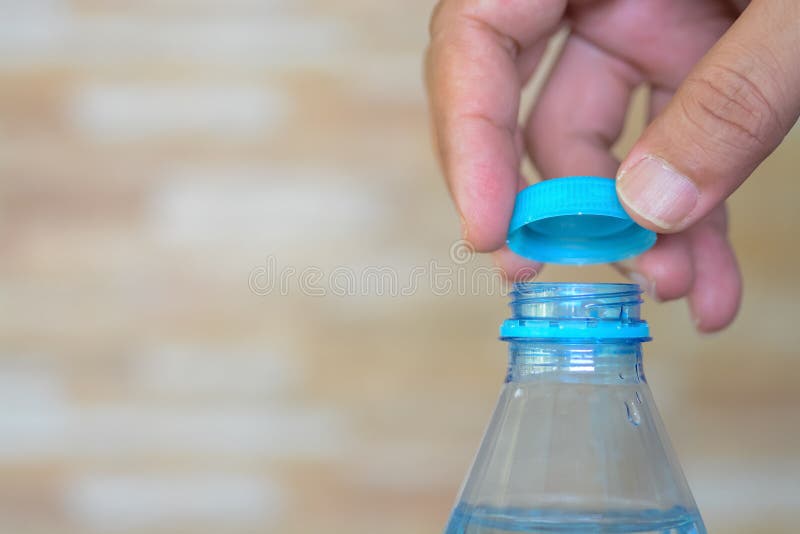 Hands Delicately Twist Open the Cap of a Refreshing Bottle of Water ...
