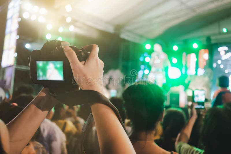 Hands with Digital Camera Taking a Picture at Stage of Music Concert ...