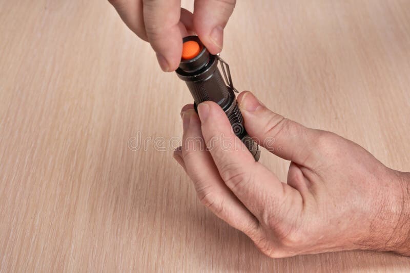 Hands Disassemble a Small Black Flashlight To Replace a Used Battery ...