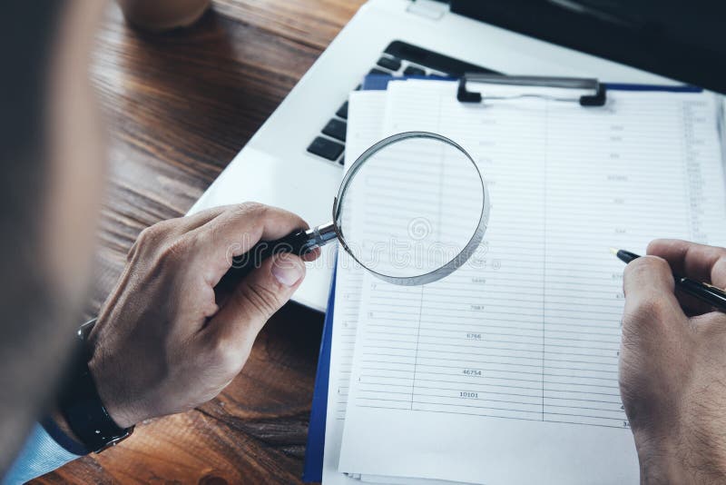 Hands with a Document and Magnifier on a Computer Keyboard Stock Image ...