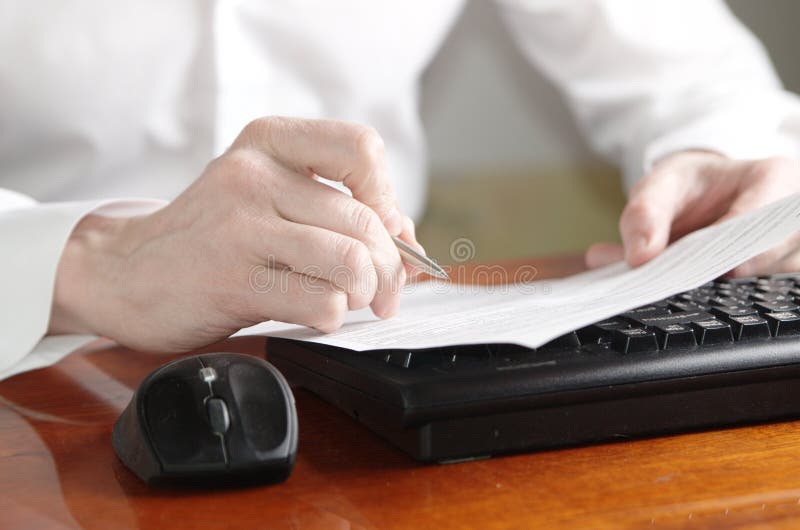 Hands with Document and Pen on a Computer Keyboard Stock Photo - Image ...
