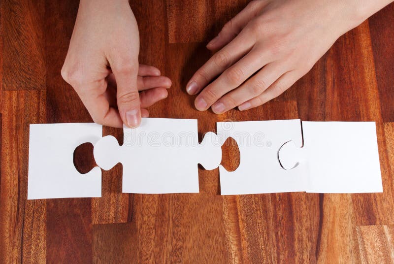 Hands doing a puzzle stock photo. Image of gameplaying - 30565400