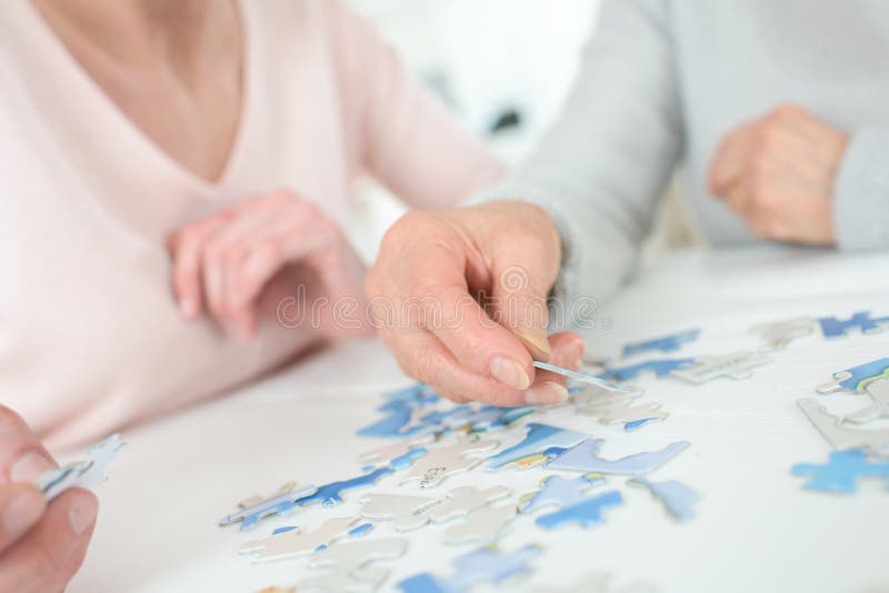 Hands doing puzzles stock image. Image of teamwork, white - 309753457