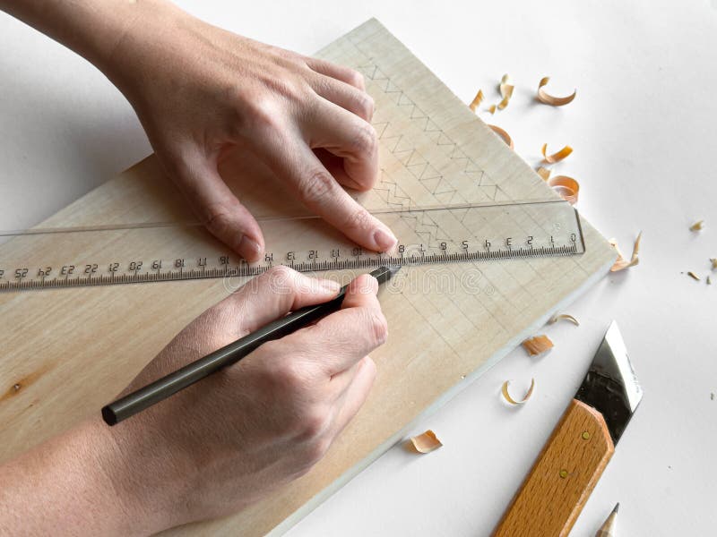 Hands Drawing Geometric Patterns on Wood with Pencil and Ruler Stock ...
