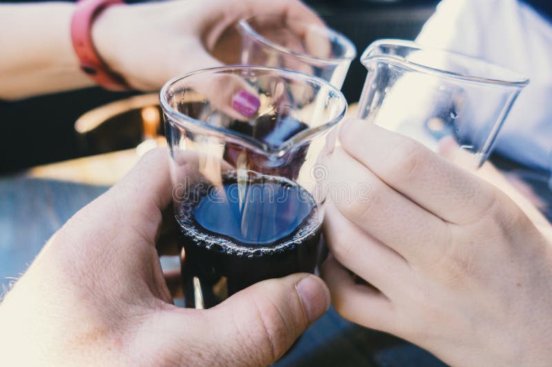 Hands with Drinks in Glasses at the Table Stock Photo - Image of ...