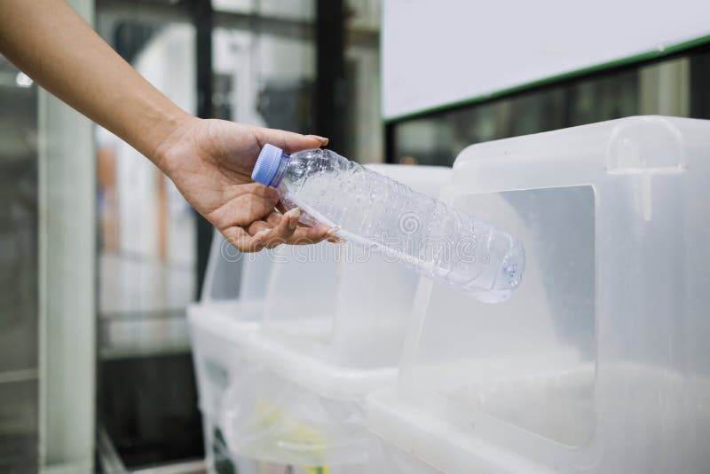 Hands Dropping Used Clear Plastic Bottles into the Trash Stock Photo ...