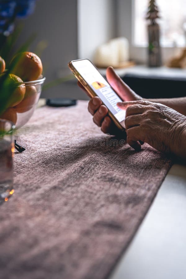Hands of an Elderly Woman Holding a Mobile Phone. Stock Image - Image ...